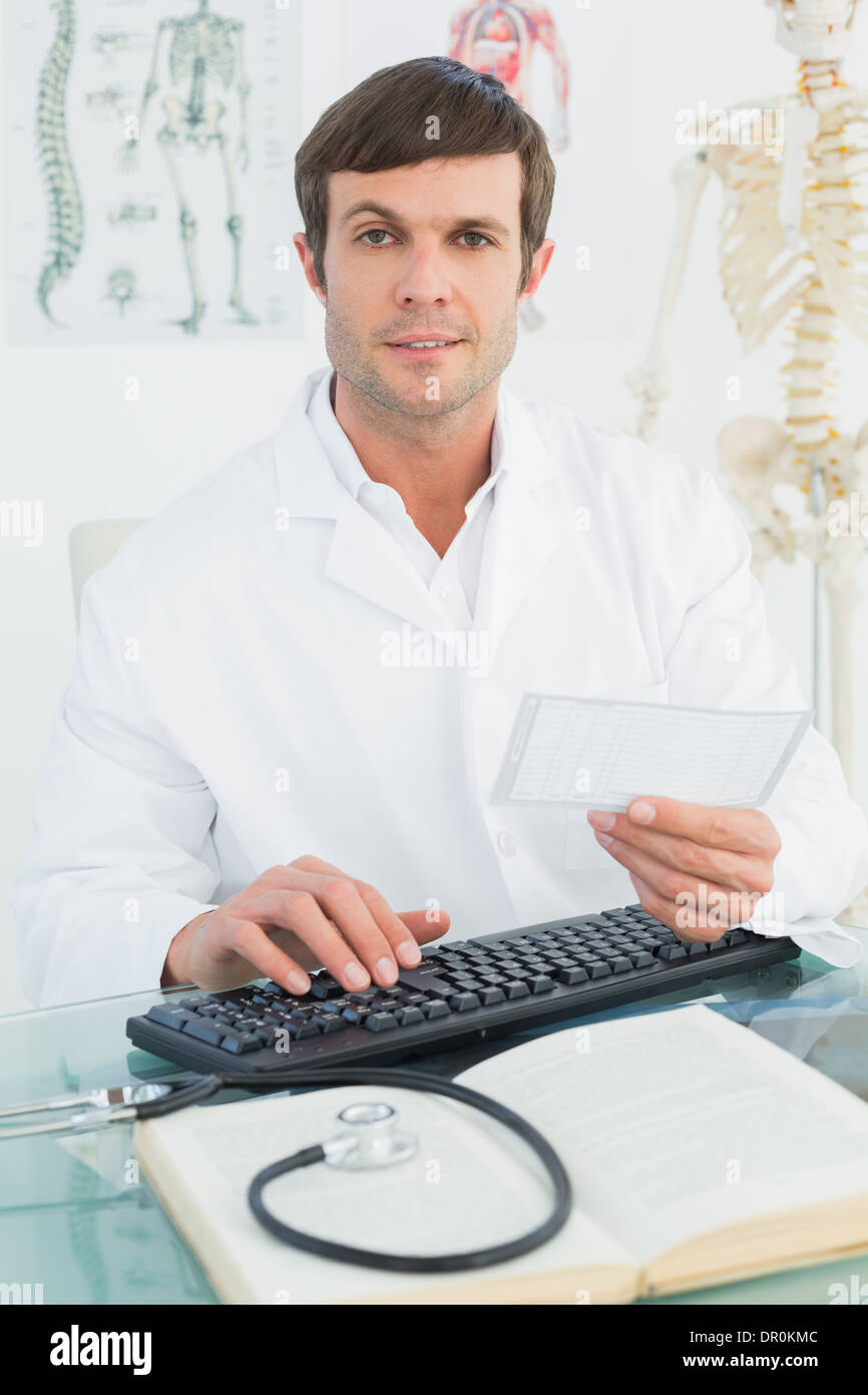 Doctor reading book table hi-res stock photography and images - Alamy