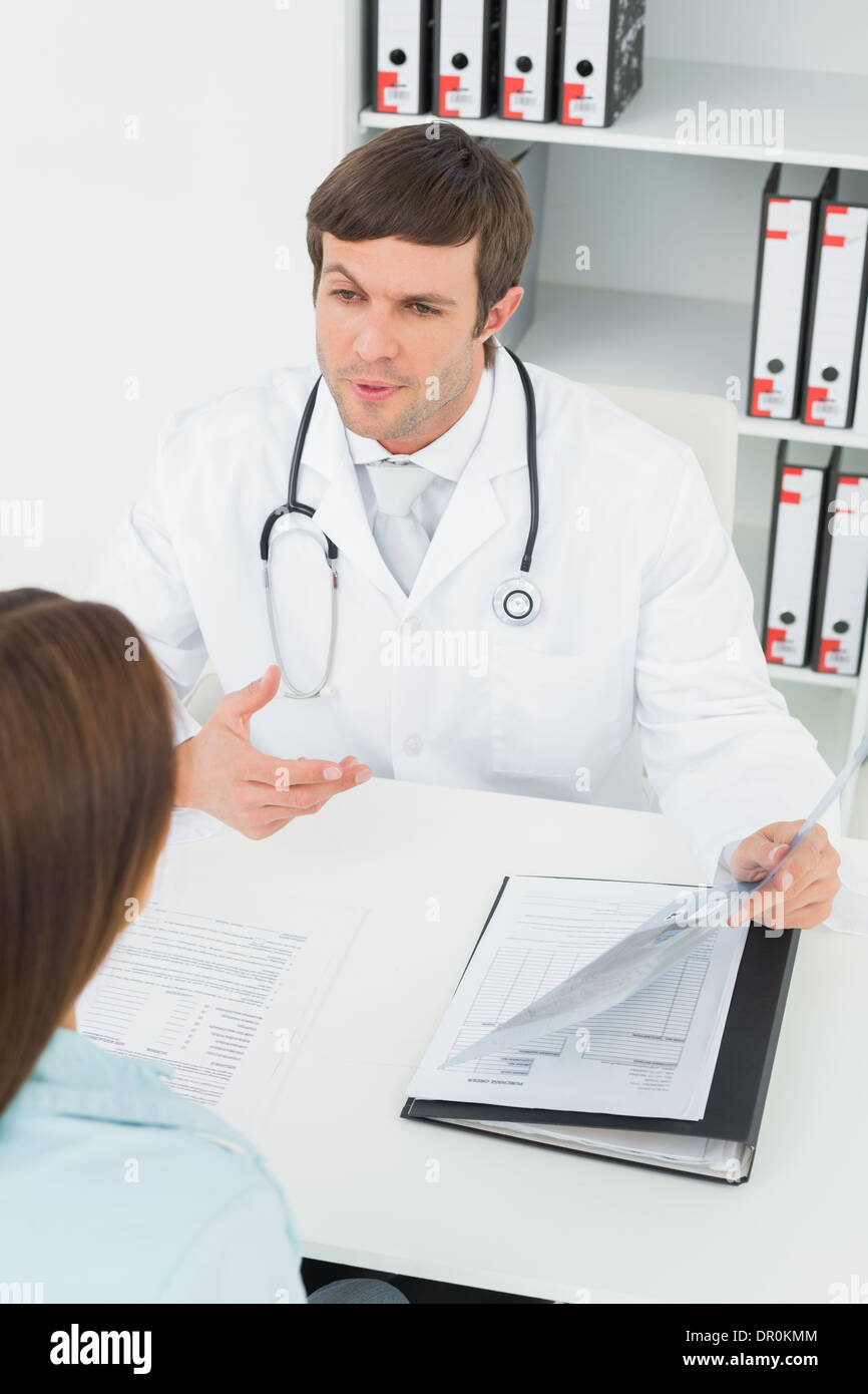 Doctor in conversation with female patient in medical office Stock ...