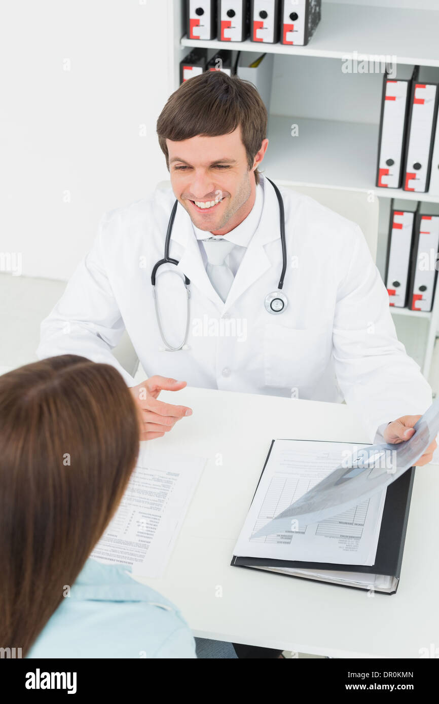 Doctor in conversation with female patient in medical office Stock ...