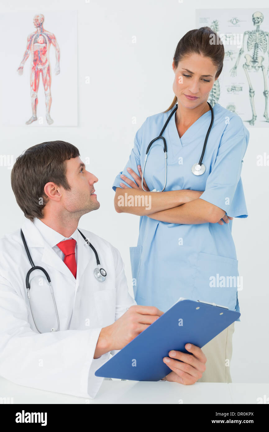 Doctors with reports in medical office Stock Photo - Alamy