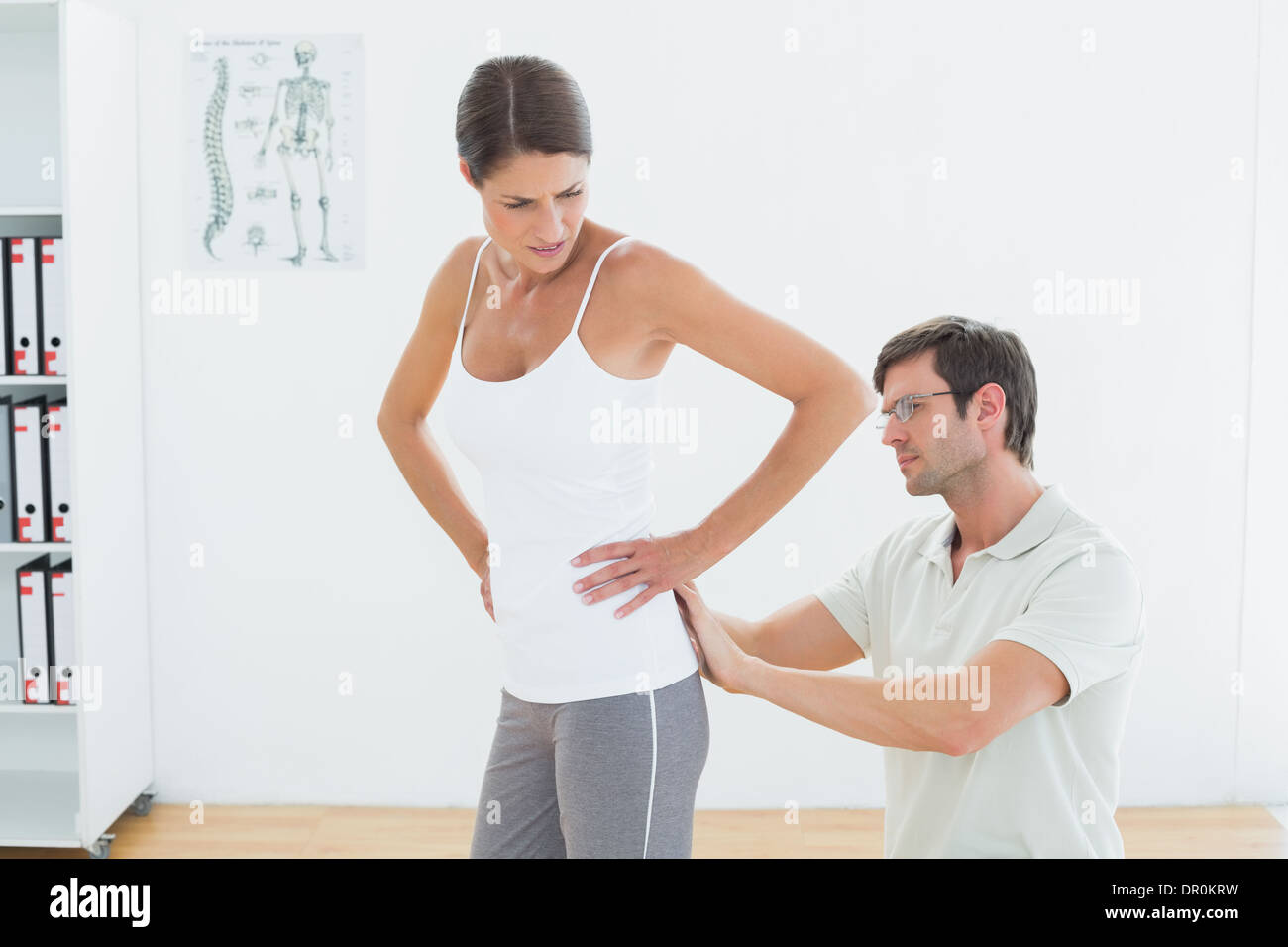 Physiotherapist examining woman's back in medical office Stock Photo ...