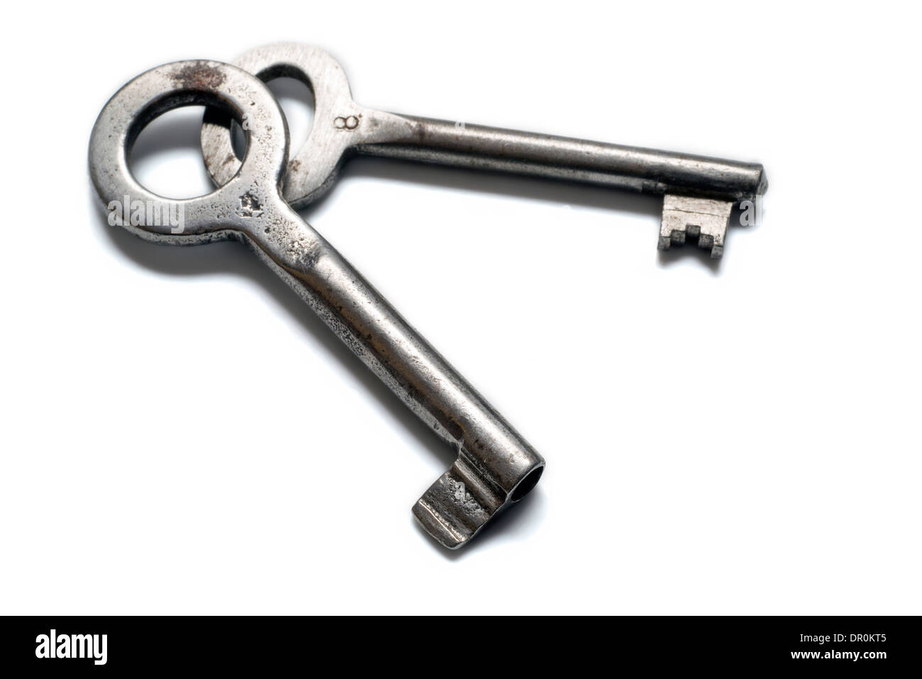 Two antique silver keys overlapping. Isolated over white Stock Photo ...