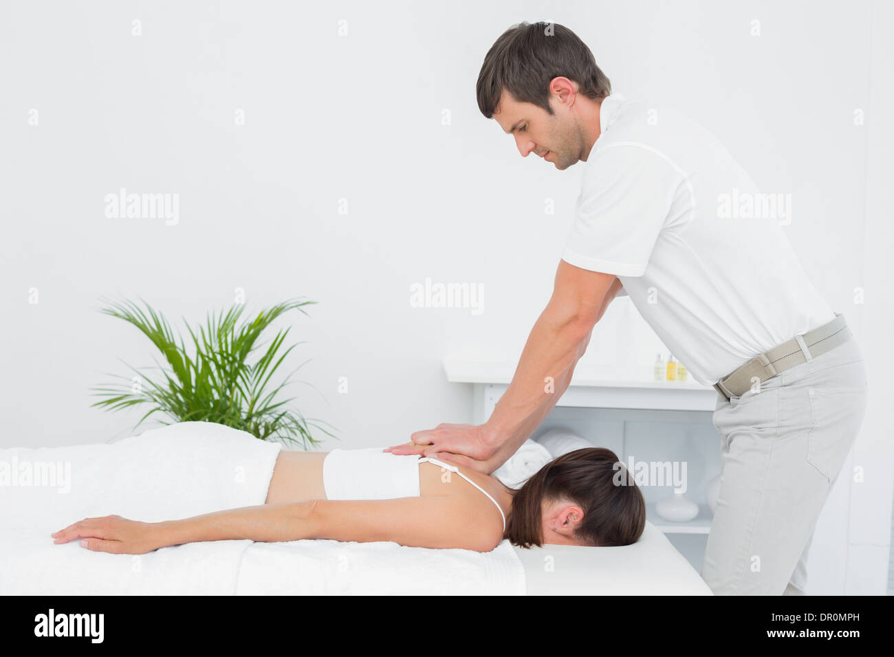 Massaging the back hi-res stock photography and images - Alamy