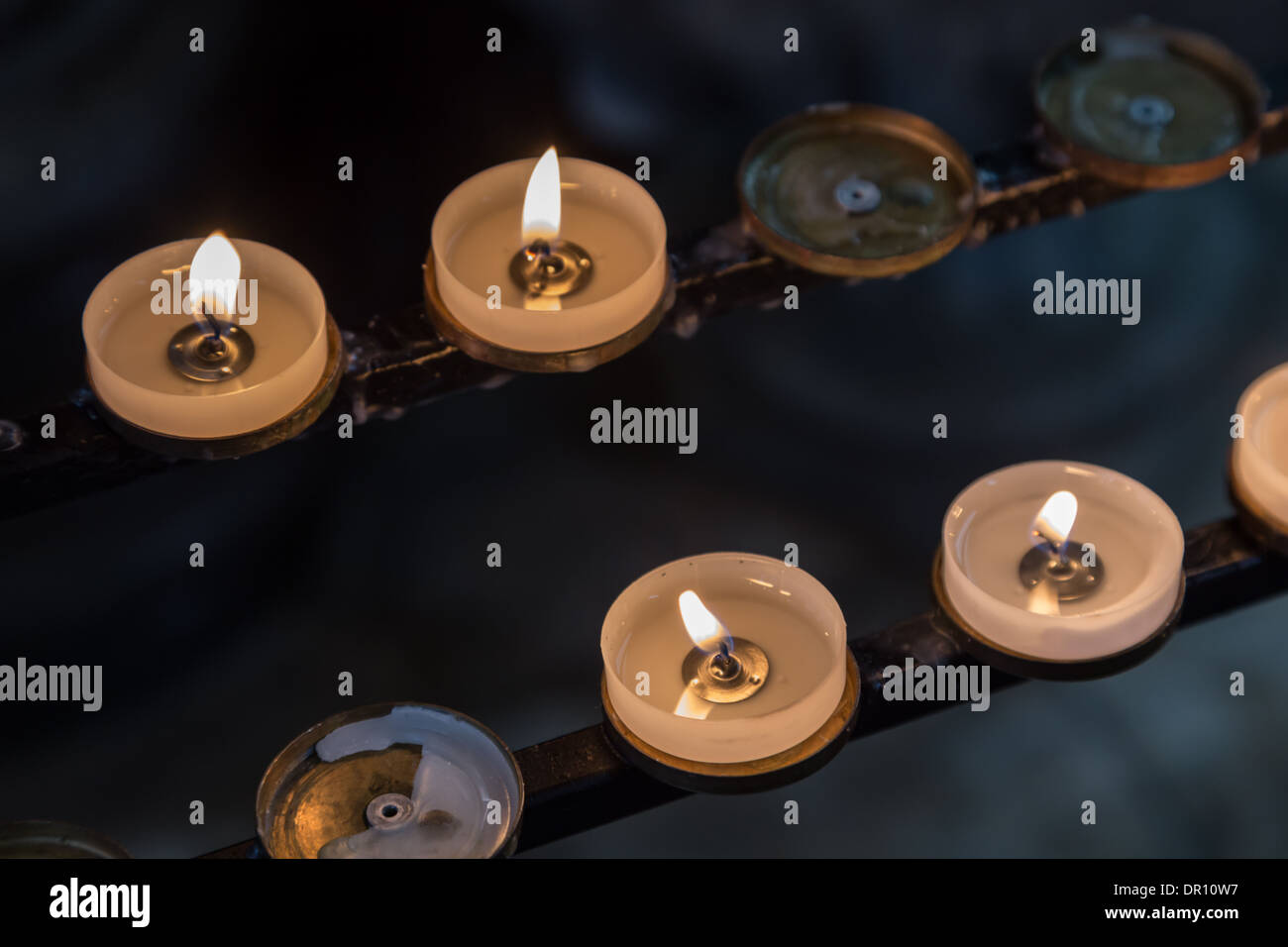 Church candles on iron rack Stock Photo - Alamy