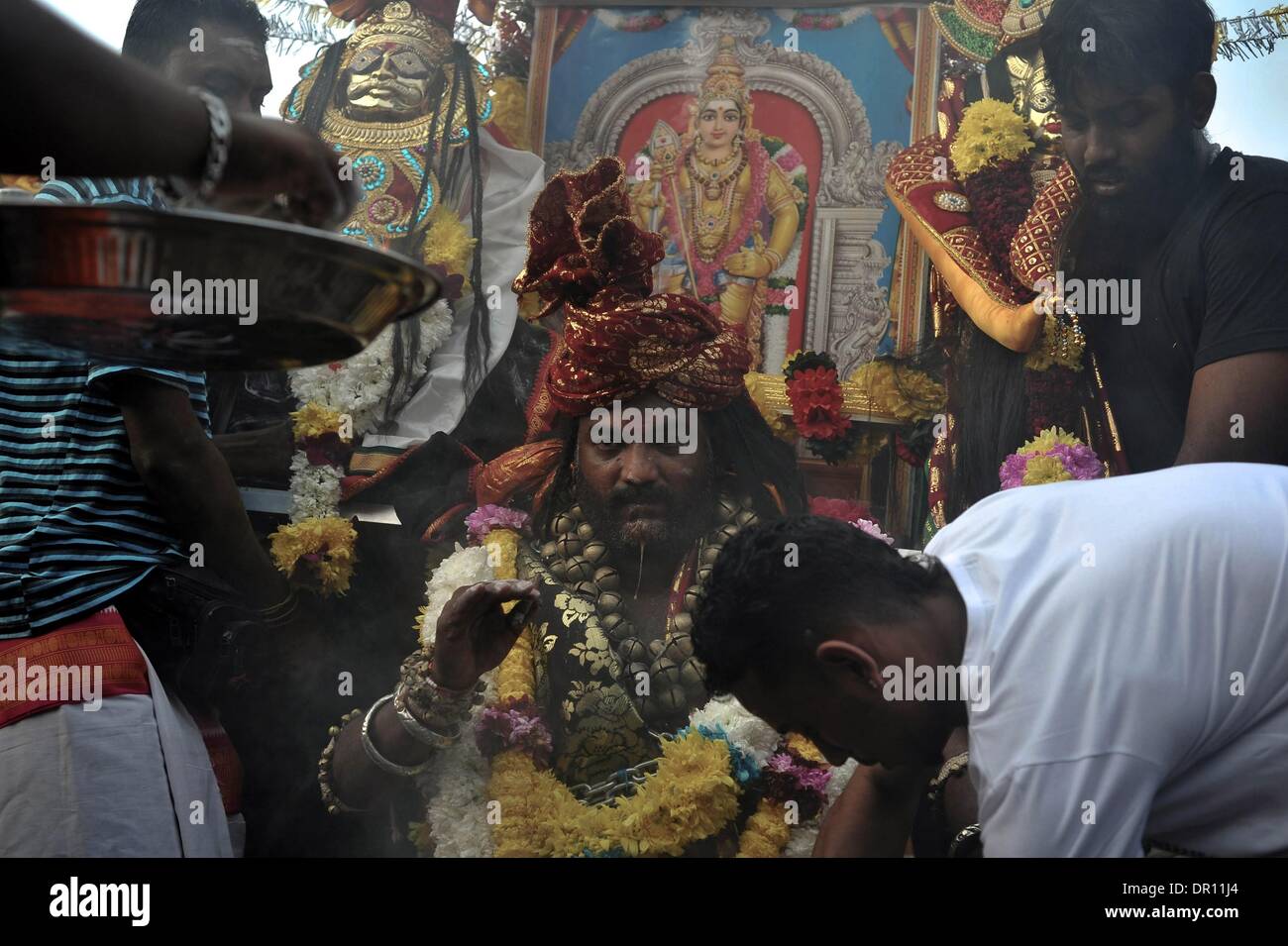 Kuala Lumpur, MALAYSIA, . 17th Jan, 2014. A devotee runs through his ...