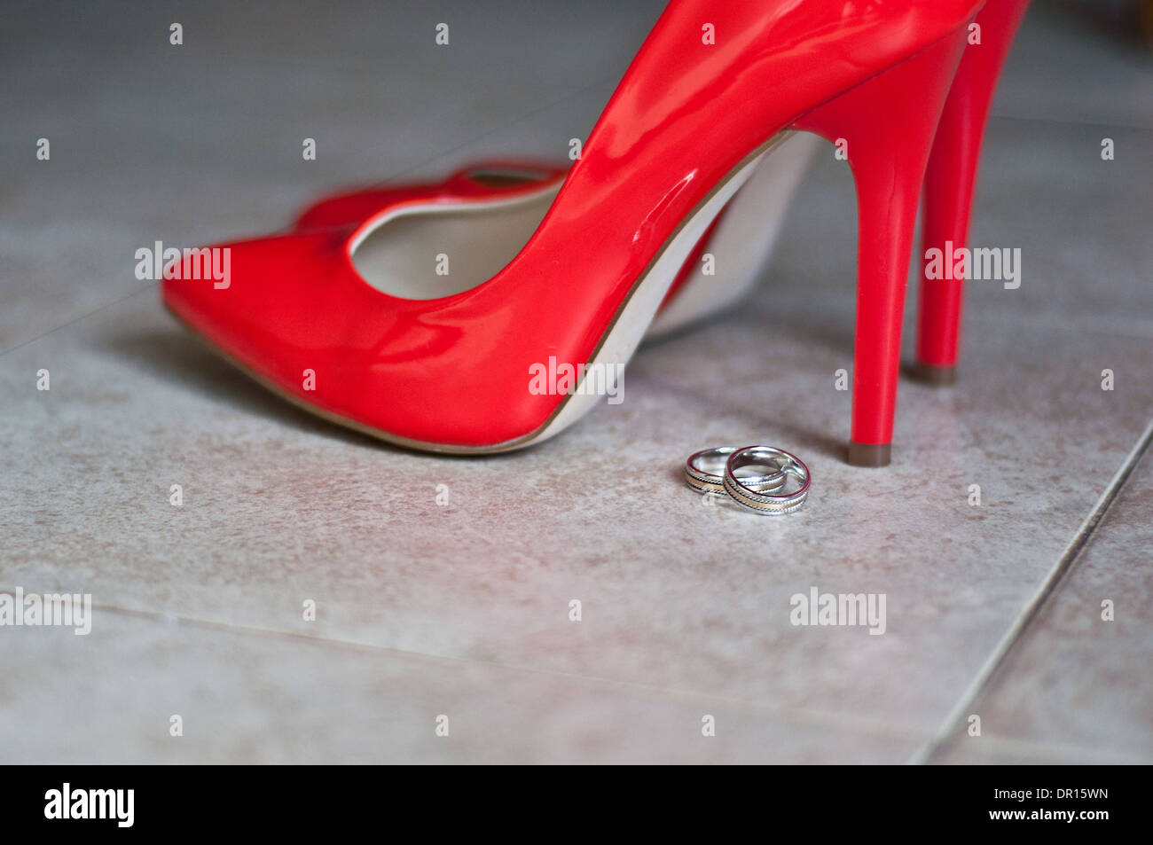 wedding red shoes of the bride and wedding rings Stock Photo - Alamy