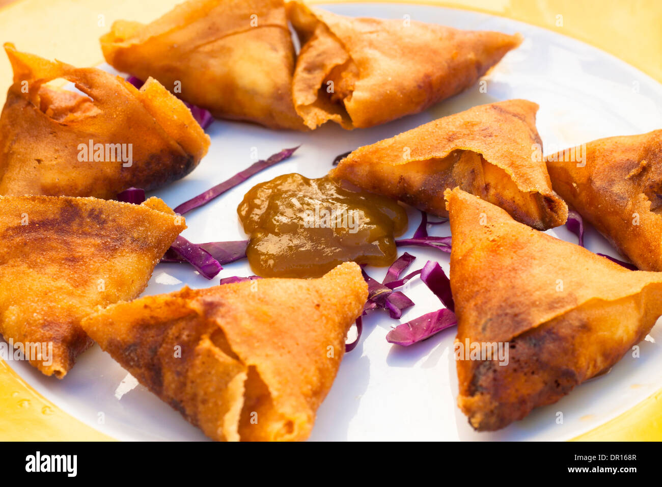 Spanish Tapas plate with golden fried filled pastry triangles and sauce ...