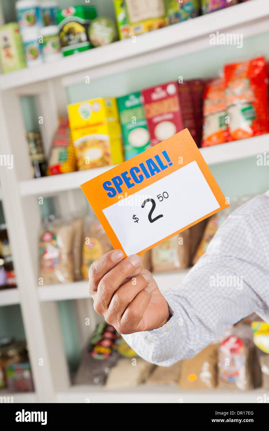 Male Owner Holding Discount Sign In Supermarket Stock Photo - Alamy