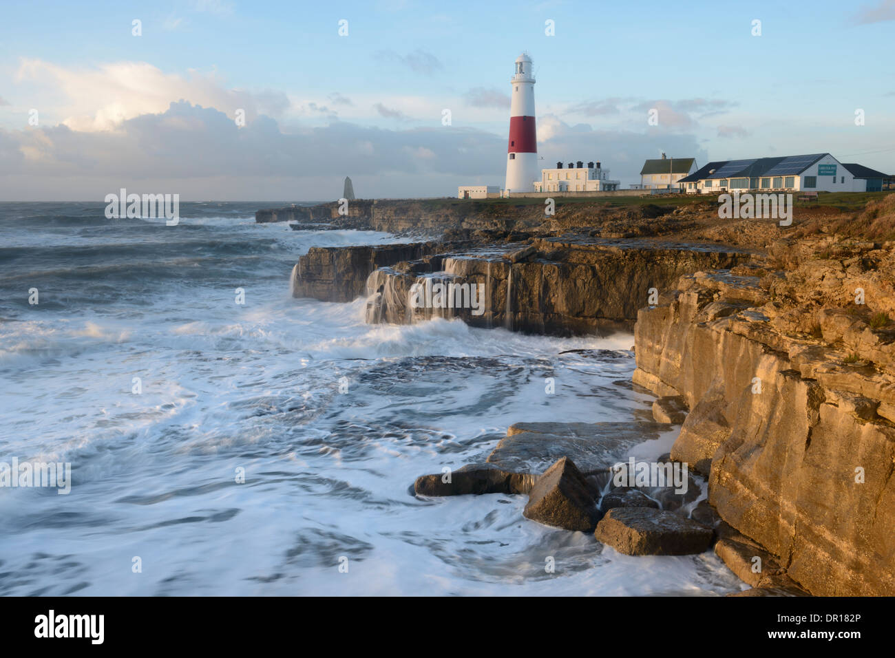 Rough seas crash over rocks near Portland Bill Lighthouse, Dorset Stock ...