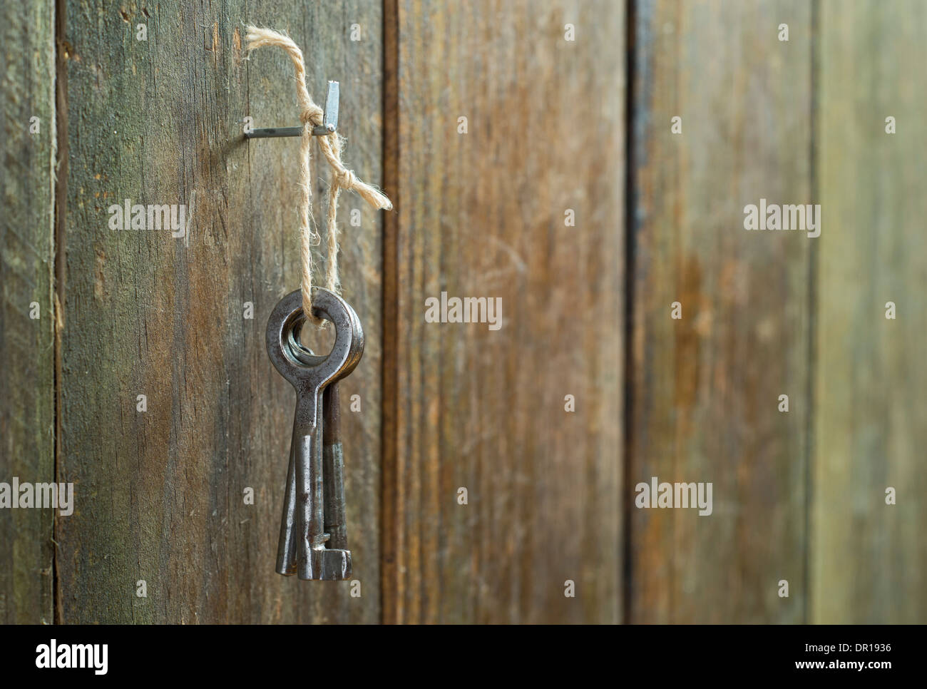 old keys tied with string and hanging from a spike Stock Photo - Alamy