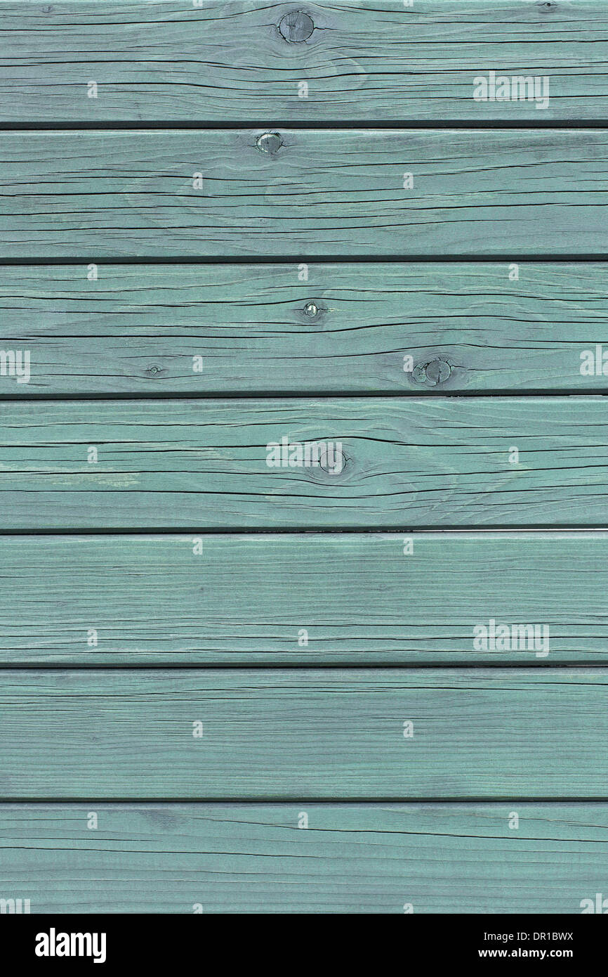 Wooden pine boards lying together in green color with lines and knots ...
