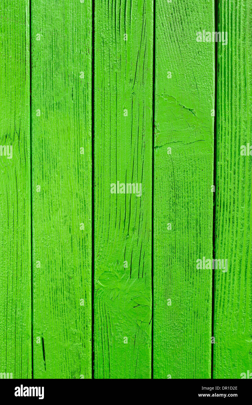 Wooden pine boards lying together in green color with lines and knots ...