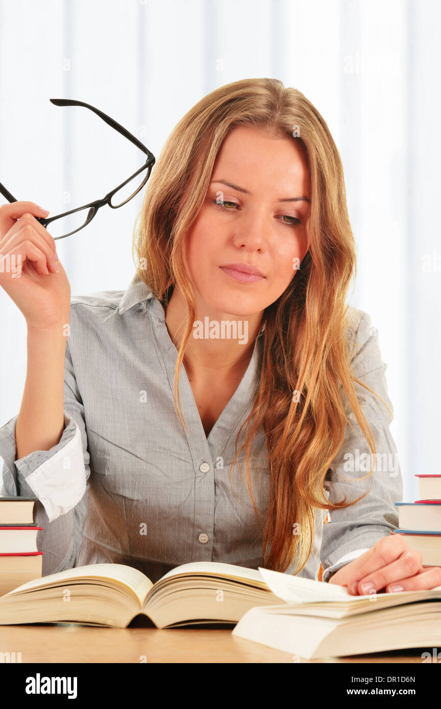 Female student reading in the library Stock Photo - Alamy