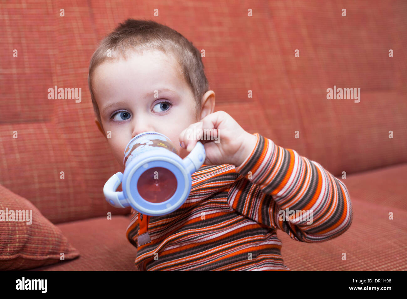 Child boy with drink bottle at home Stock Photo - Alamy