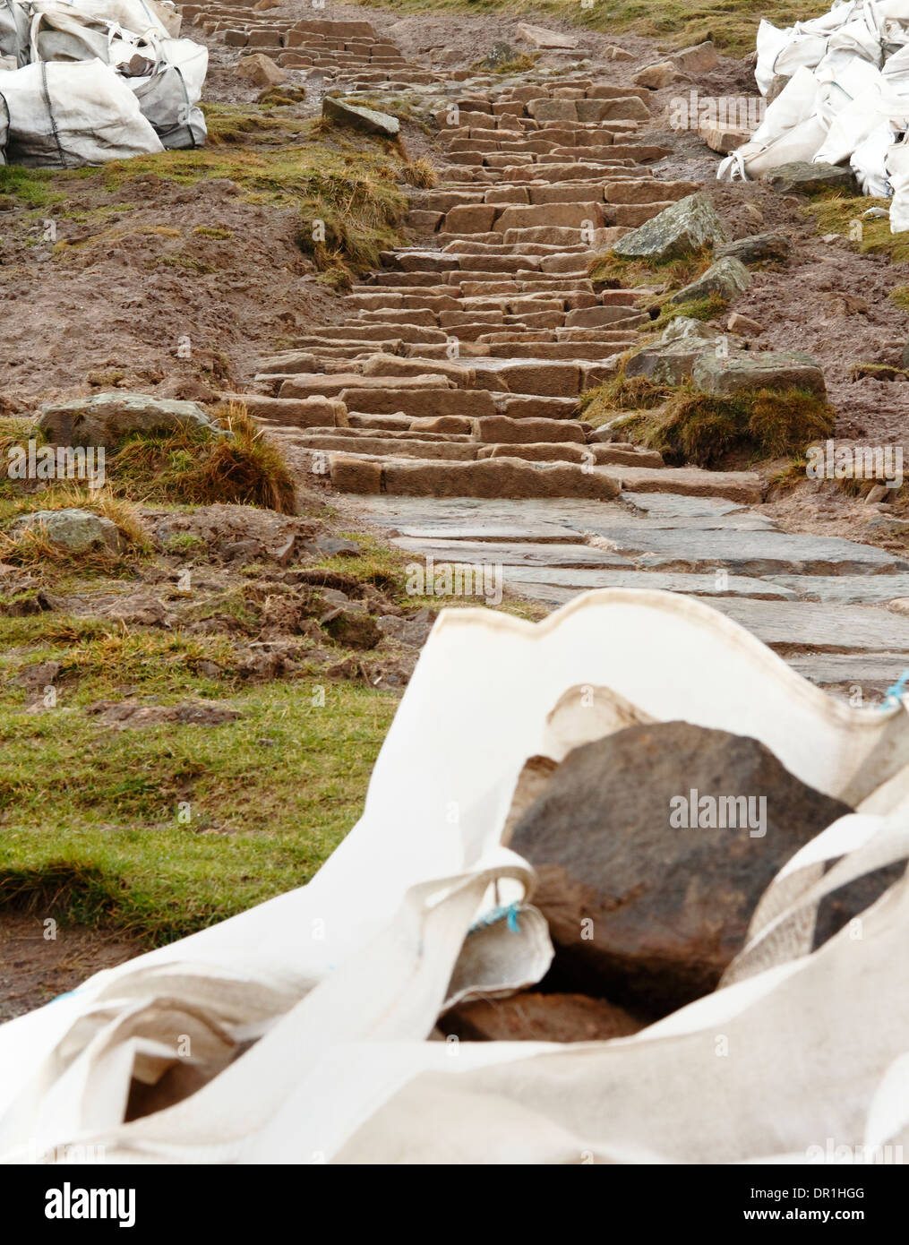 Repair of eroded stone footpath in progress on Mam Tor, a popular ...