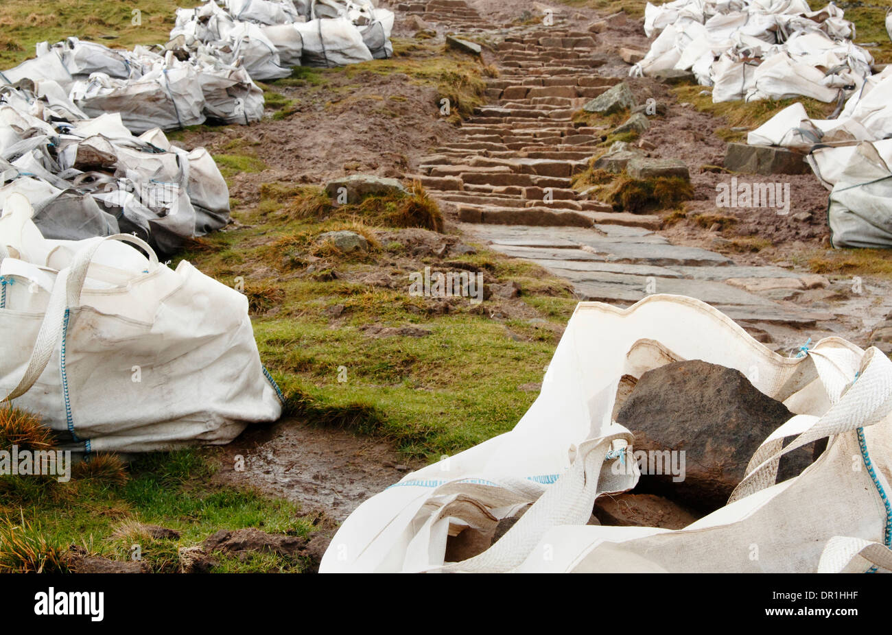 Repair of eroded stone footpath in progress on Mam Tor, a popular ...
