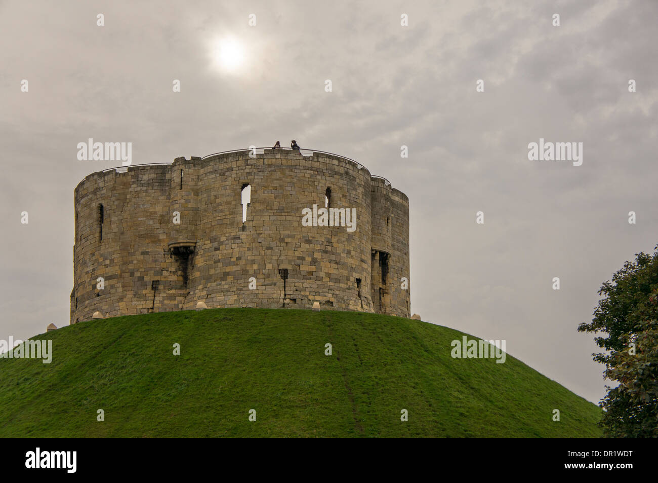 Under grey sky, visitors stand on high ramparts of Clifford’s Tower ...