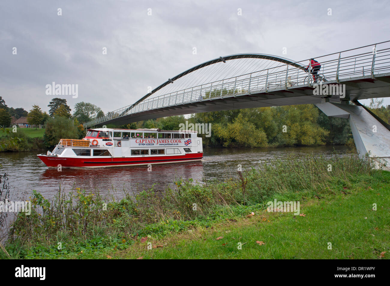 Passengers enjoy trip sailing on River Ouse aboard small cruise boat ...