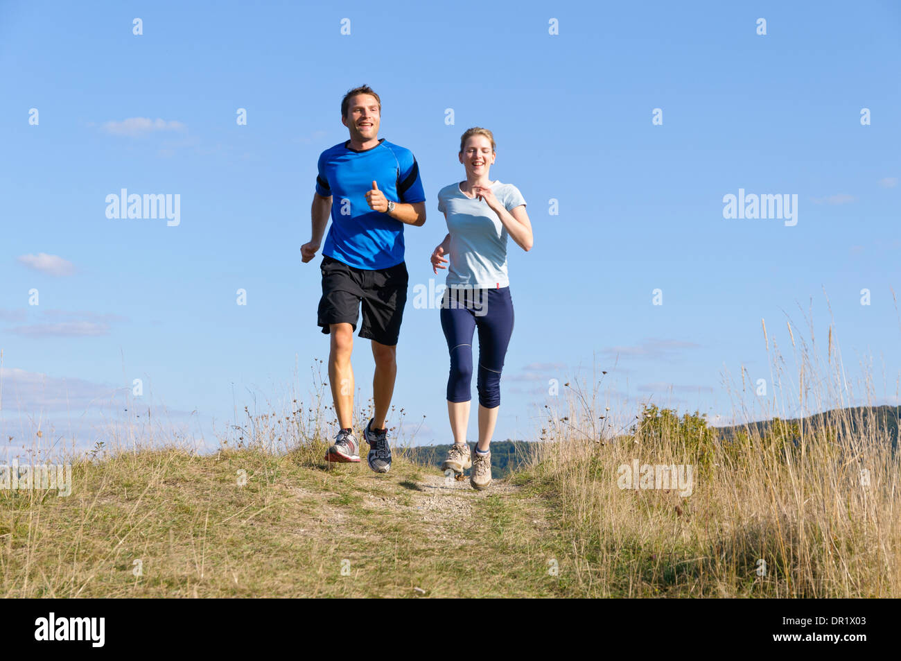 Man and woman jogging together Stock Photo - Alamy