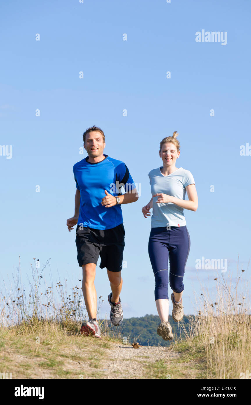 Man and woman jogging together Stock Photo - Alamy
