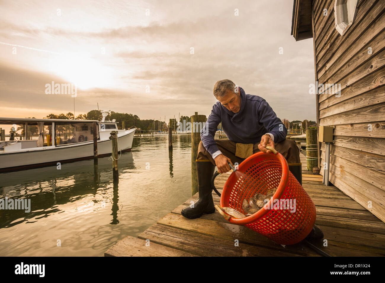 Man sitting on bucket fishing hi-res stock photography and images - Alamy