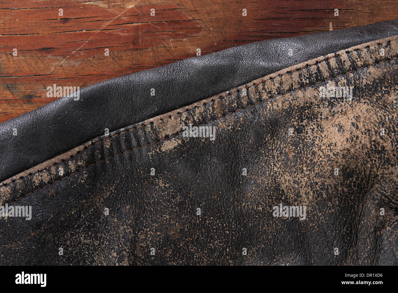 Vintage threadbare leather fabric on a wood background Stock Photo - Alamy