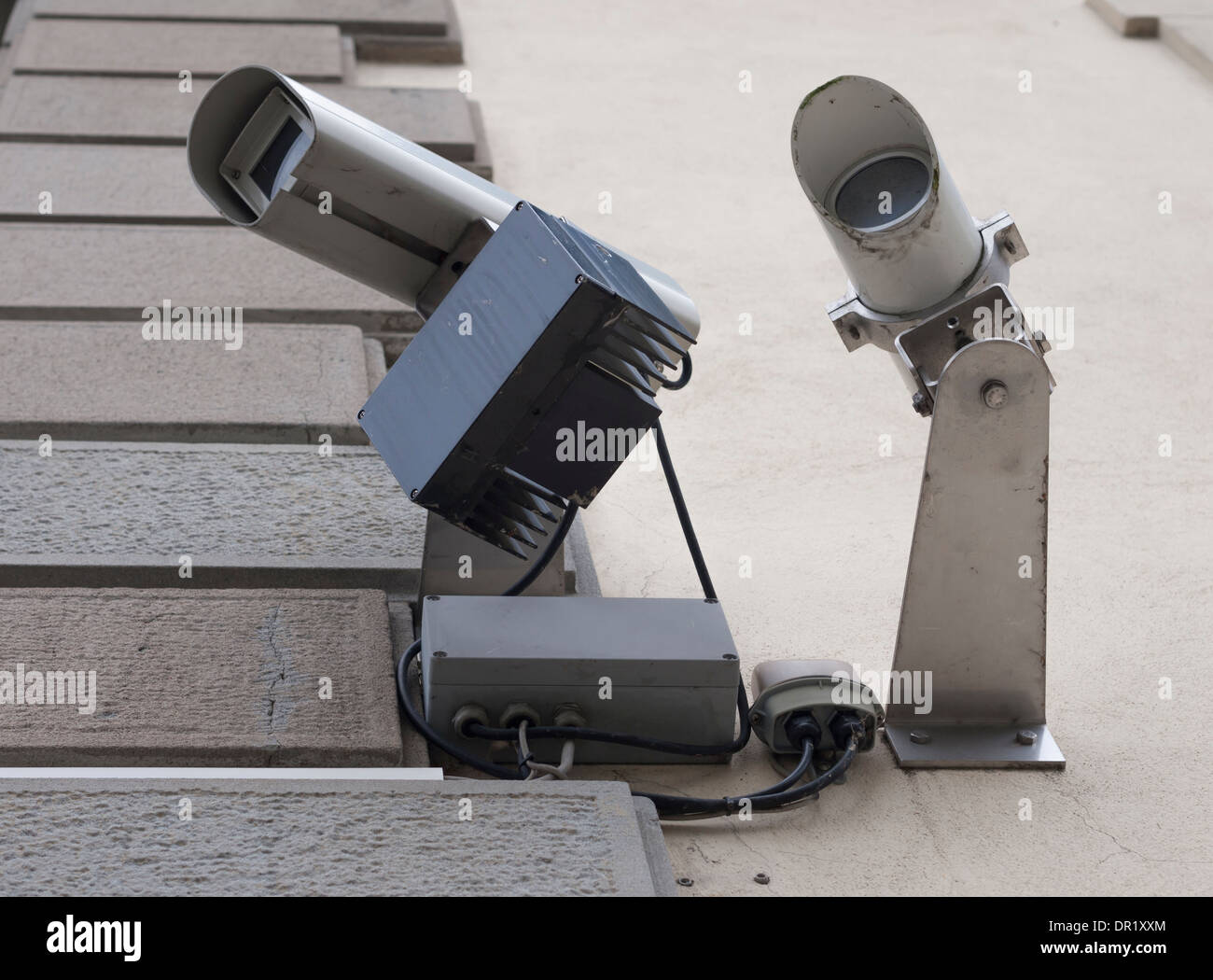 Two security cameras fixed to a building's exterior wall Stock Photo ...