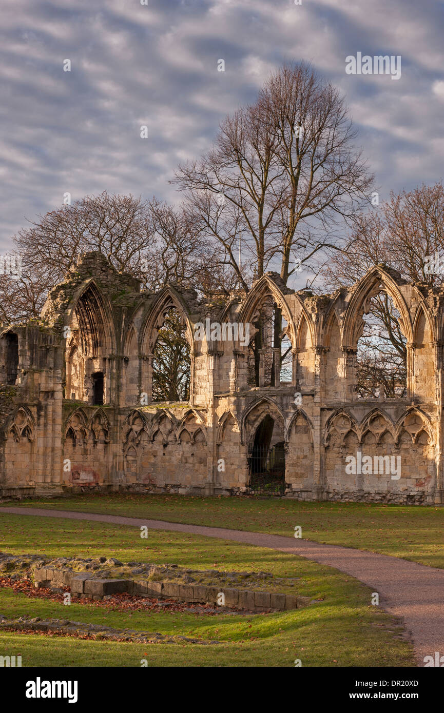 Scenic view of ancient sunlit monastic ruins with decorative arches ...