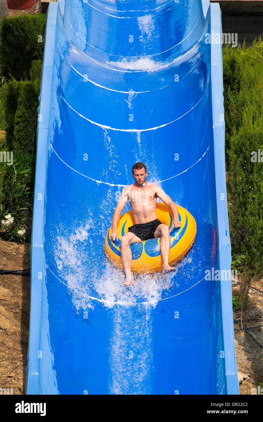 Man water sliding at aqua park Stock Photo - Alamy