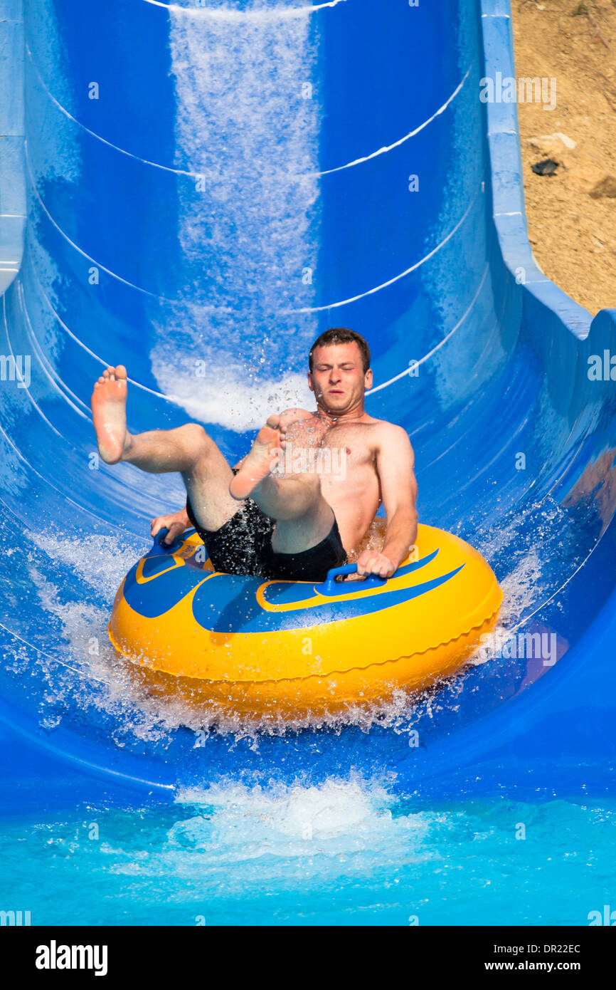 Man water sliding at aqua park Stock Photo - Alamy
