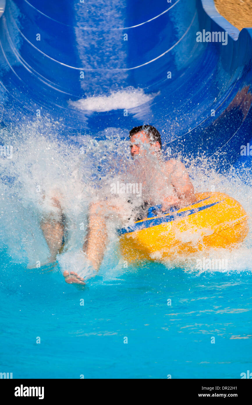 Man water sliding at aqua park Stock Photo - Alamy