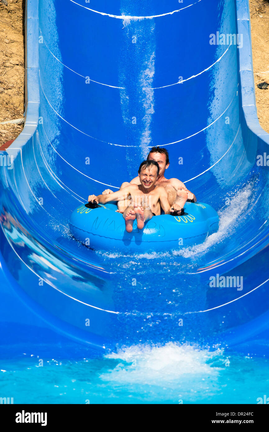 People having fun, water sliding at aqua park Stock Photo - Alamy