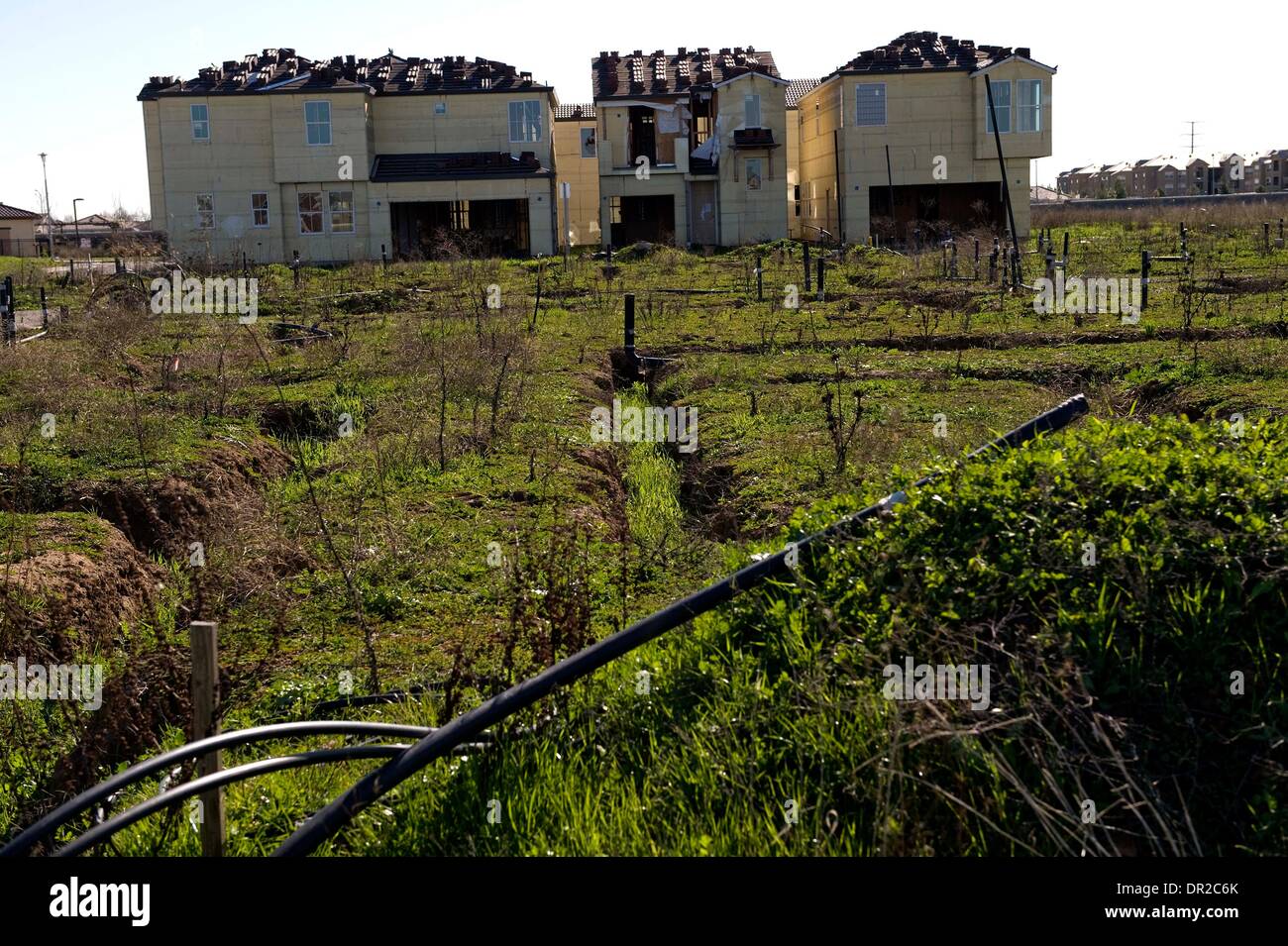 Partially built homes and vacant land await construction at the ...