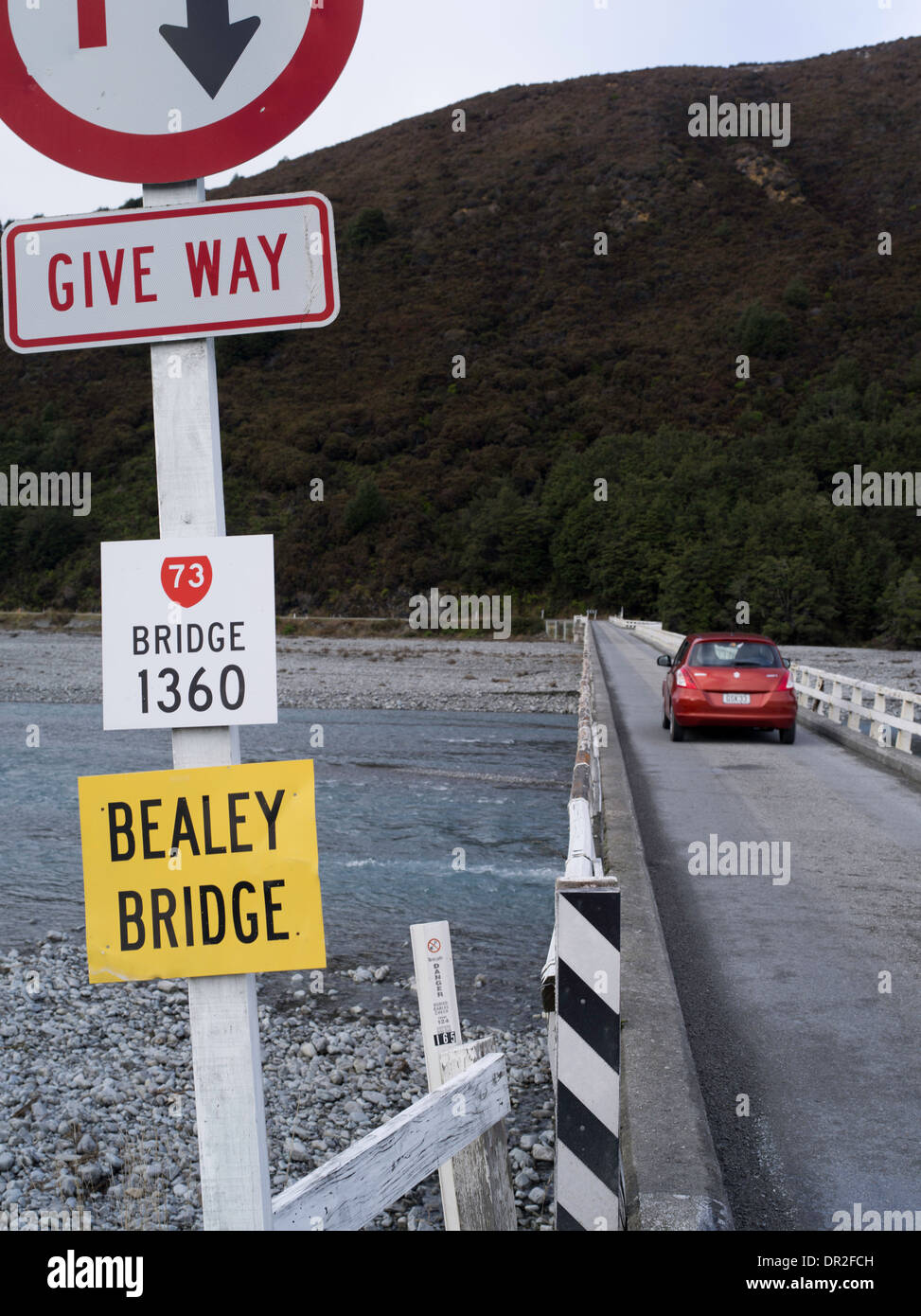 One of New Zealand's many one-lane bridges, with a crossing car, this ...