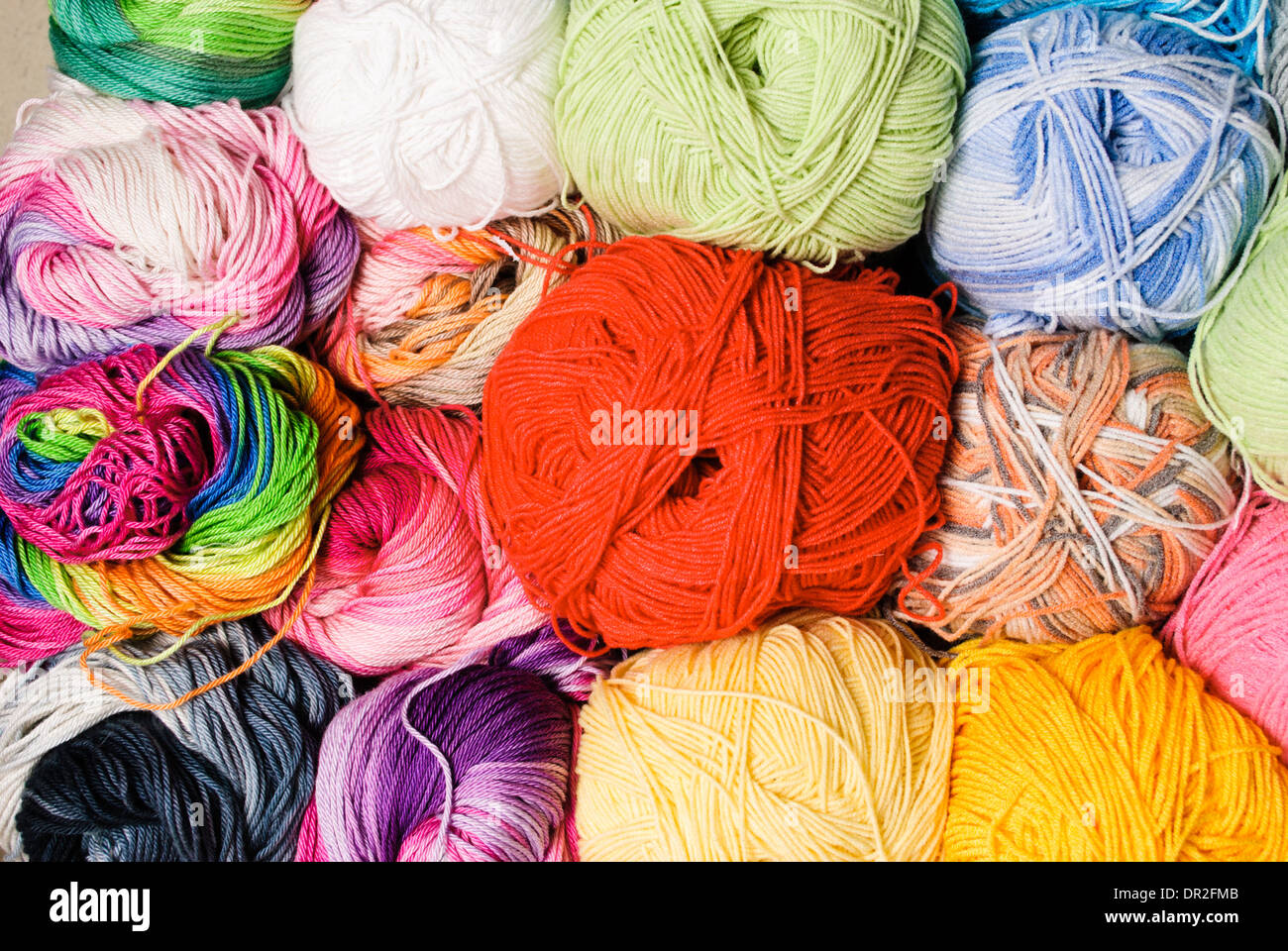 Different color threads on rows in the store Stock Photo - Alamy
