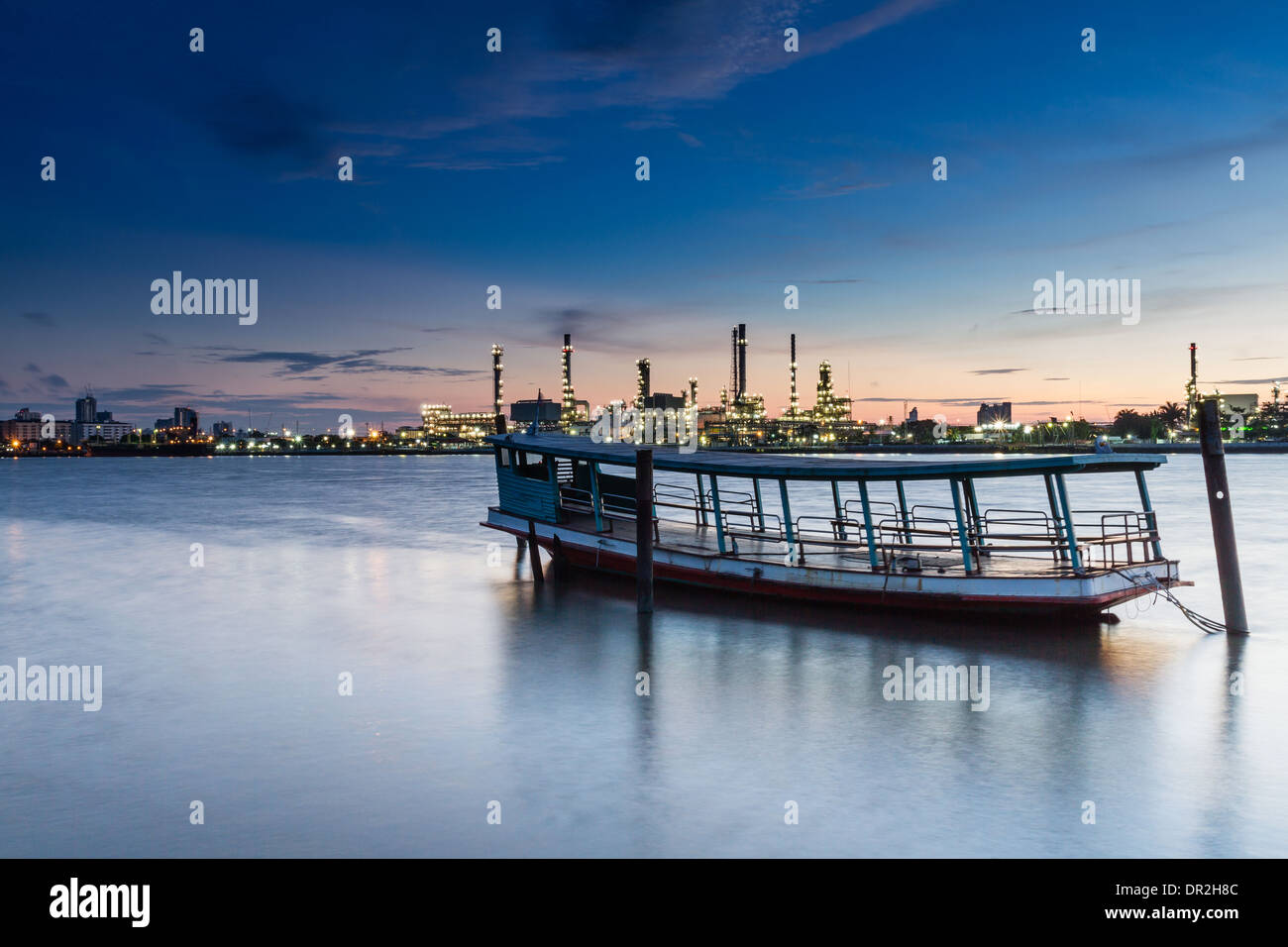 Boat with Oil refinery at twilight, Thailand Stock Photo - Alamy