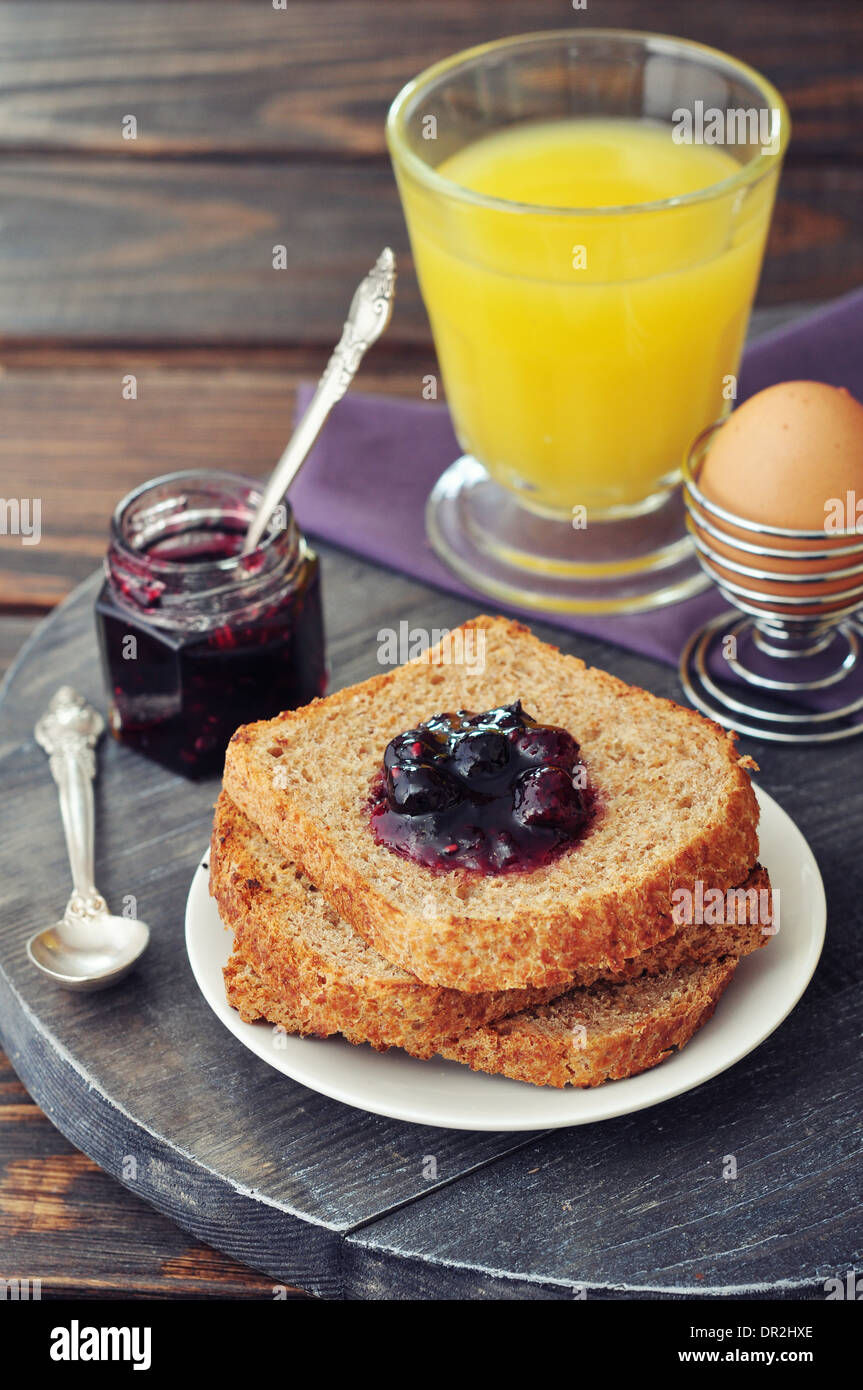 Breakfast with toast, fruit jam and orange juice on tray Stock Photo ...