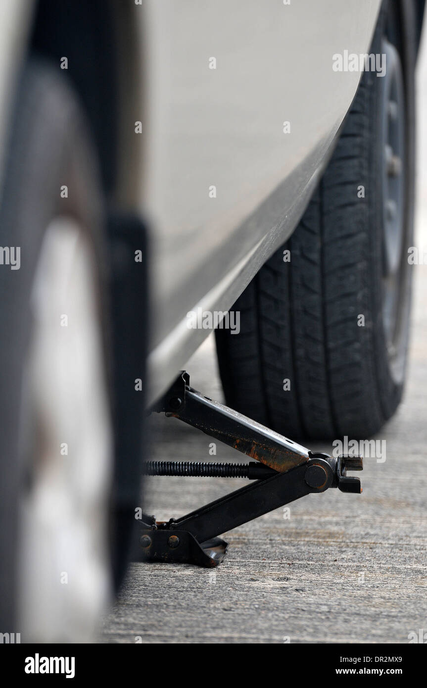 Car Maintenance checking oil and fluids and changing a tyre Stock Photo ...