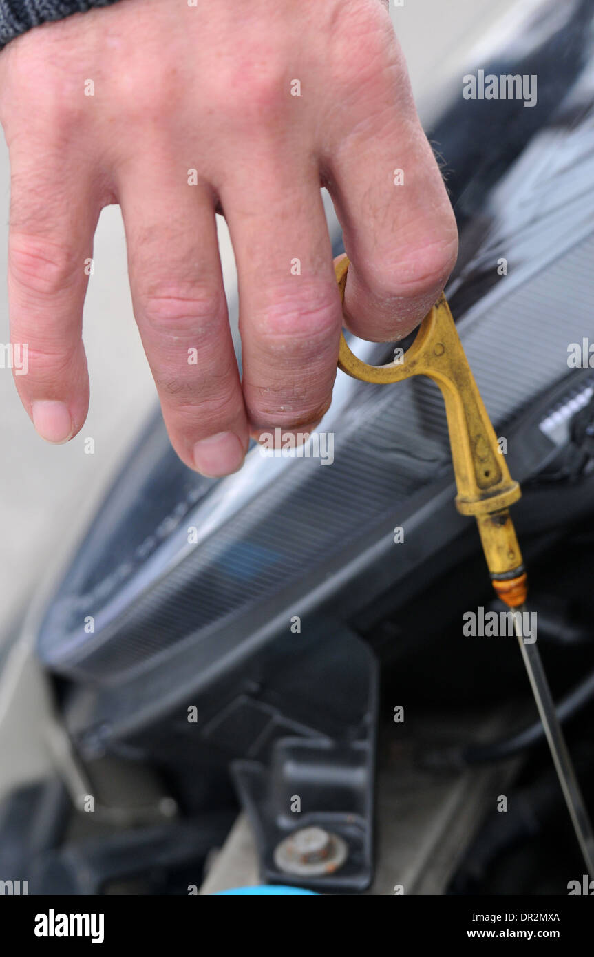 Car Maintenance checking oil and fluids and changing a tyre Stock Photo ...