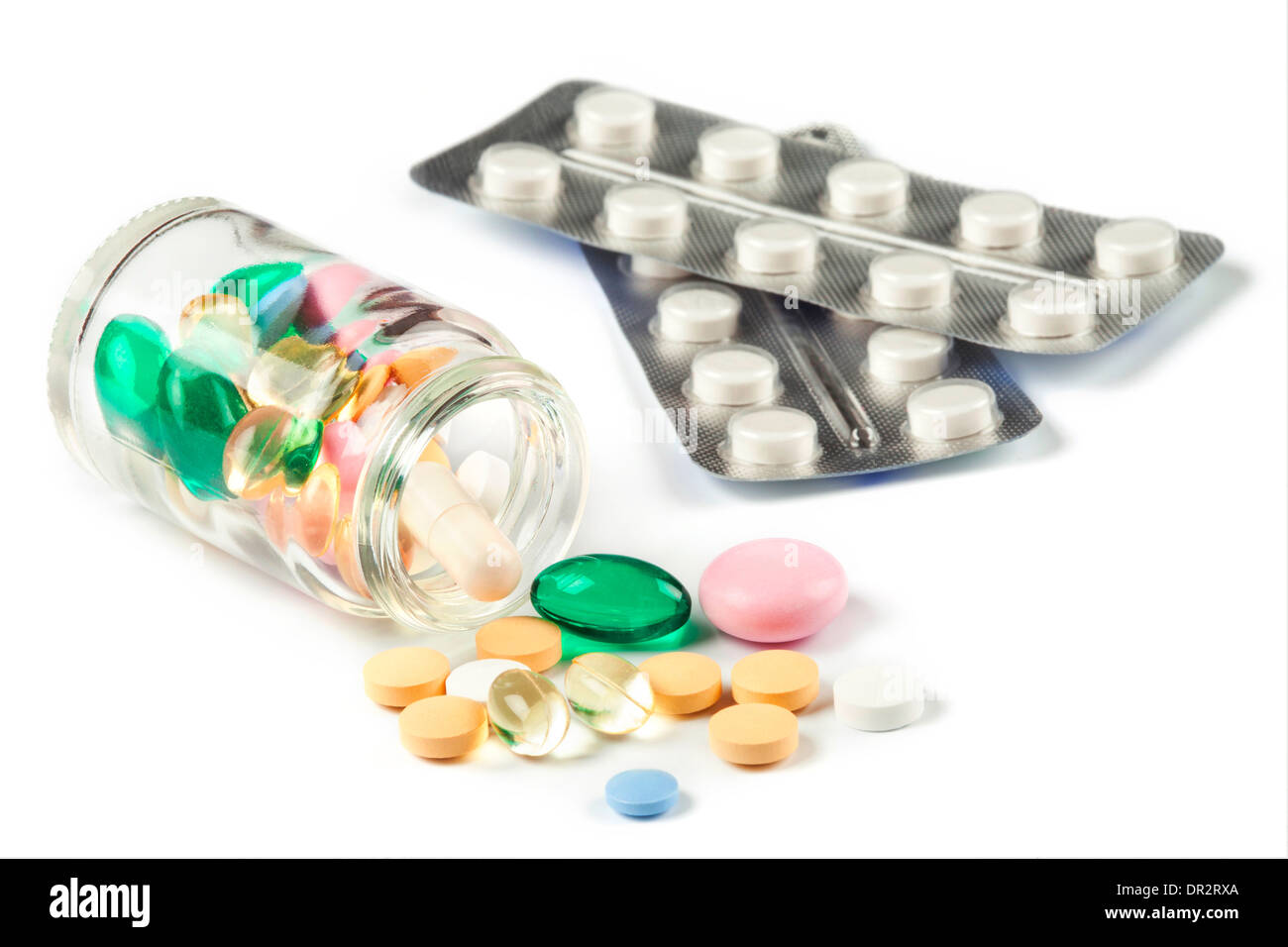 Multi color pills spills out of the little jar, bottle, two blisters of ...