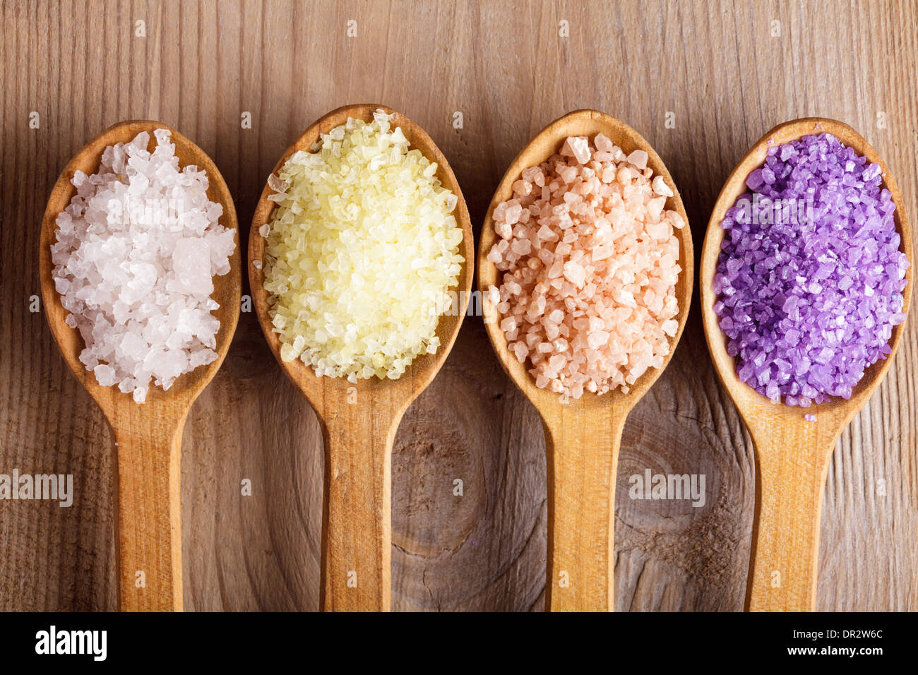 Various types of spa sea salt in wooden spoons closeup Stock Photo - Alamy