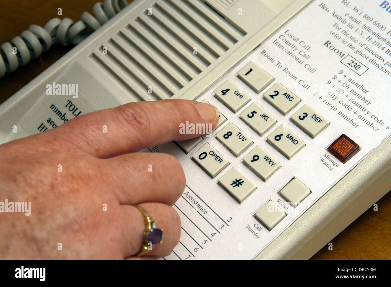 Female dialing on a hotel telephone Stock Photo - Alamy