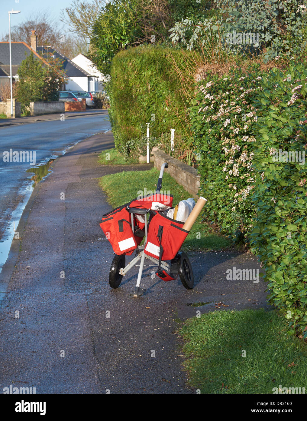 Postman's mail trolley parked while delivering to a house Stock Photo ...