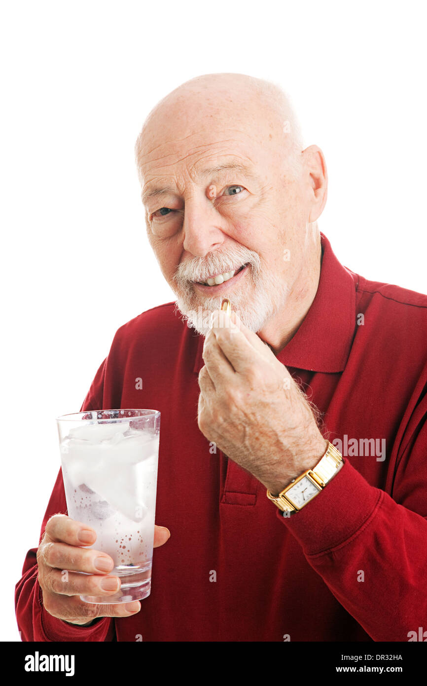Portrait of a healthy senior man taking omega 3 fish oil with a glass ...
