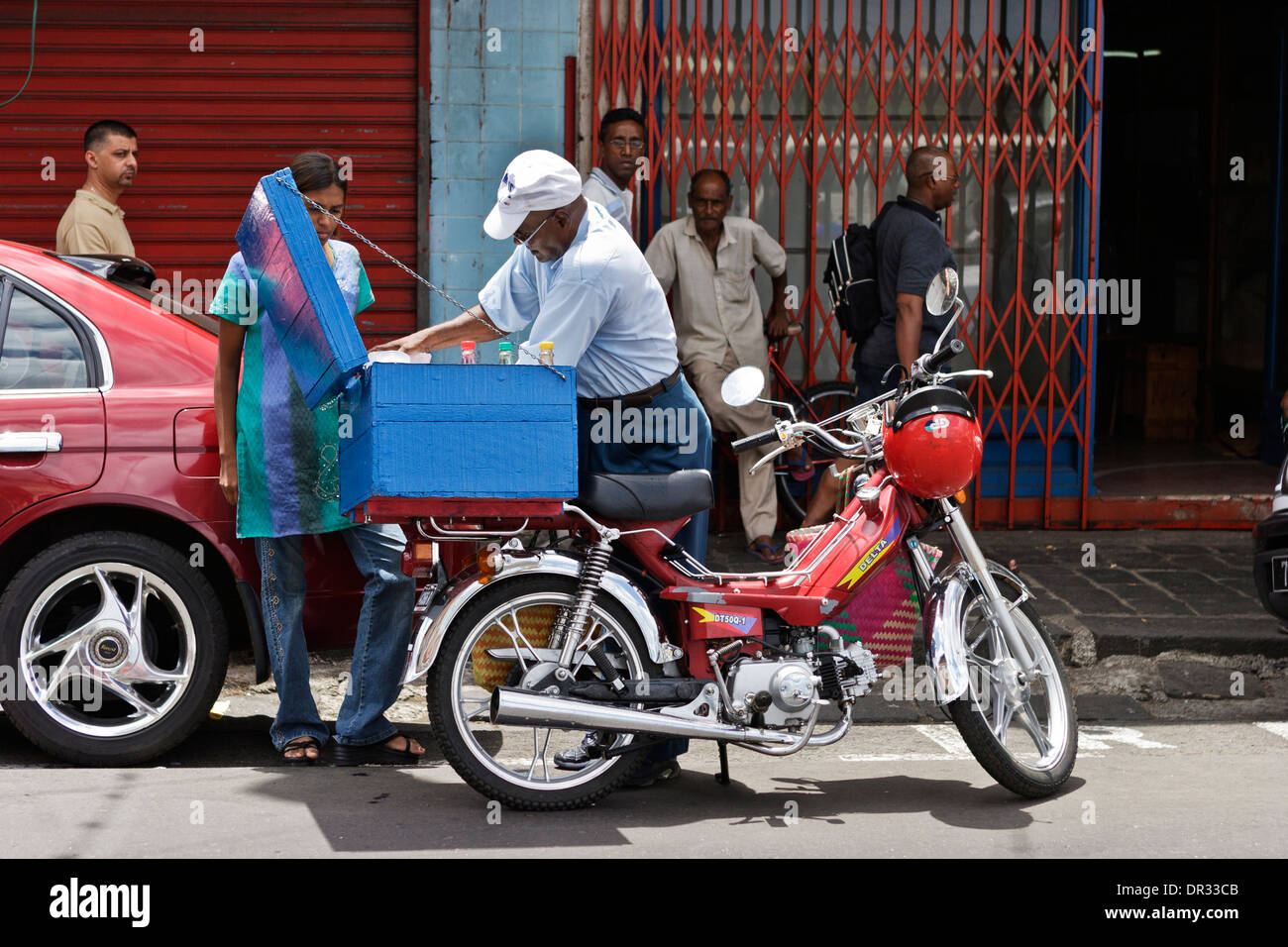 Selling of grated ice topped with syrup by seller on motorbike, Port ...