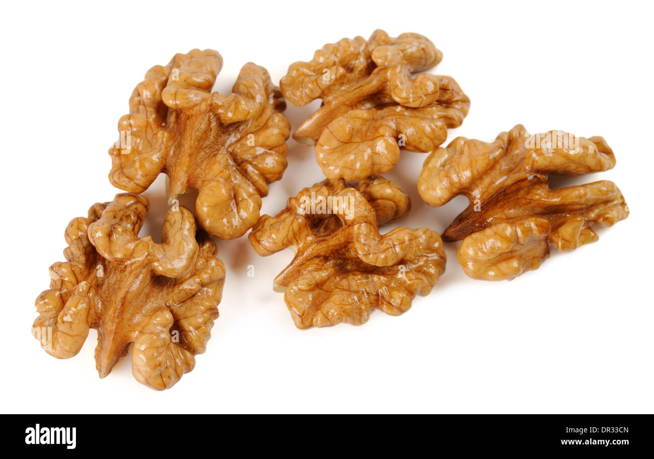 Five halves of walnut isolated on white Stock Photo - Alamy