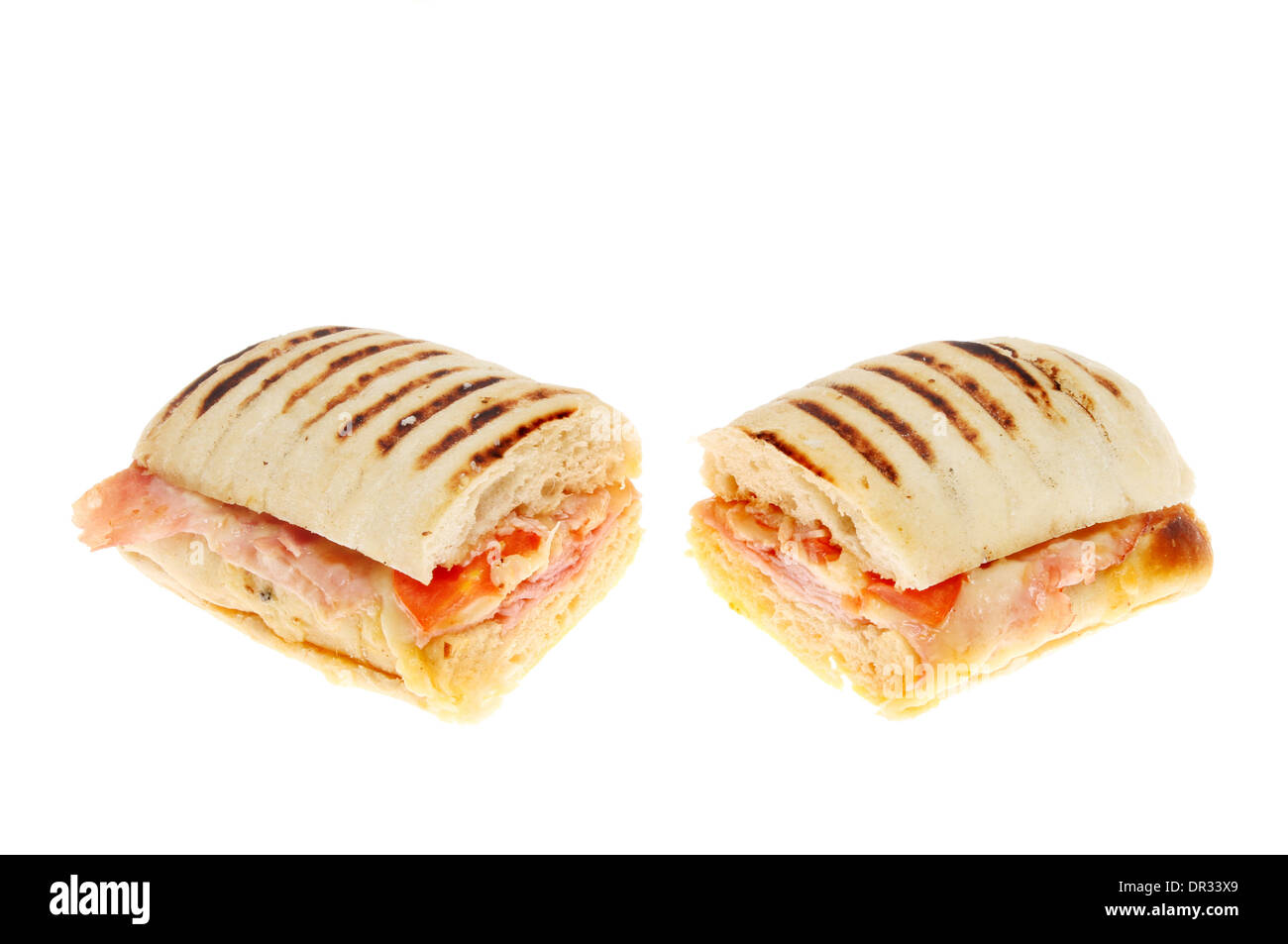 Cheese ham and tomato panini cut into two halves isolated against white ...