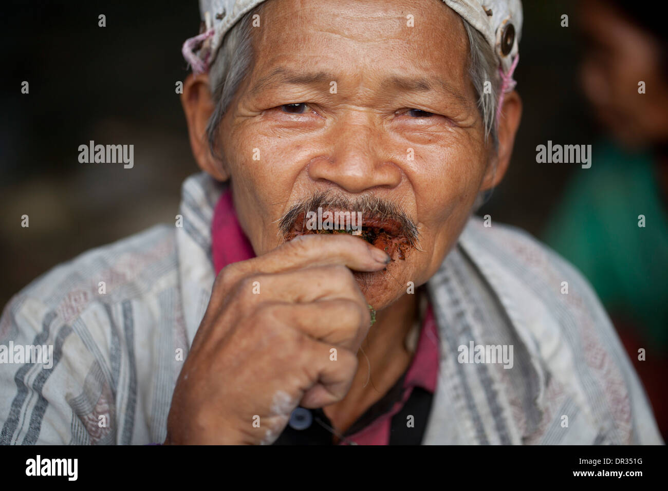 A Hanunoo Mangyan man placing fresh batch of betel chew, or nga nga, in ...