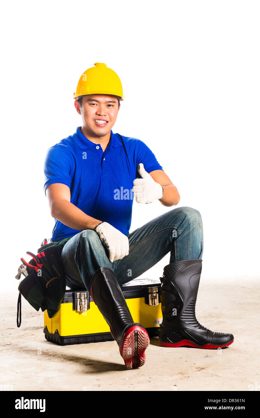Indonesian Asian builder or construction worker with helmet and tool ...