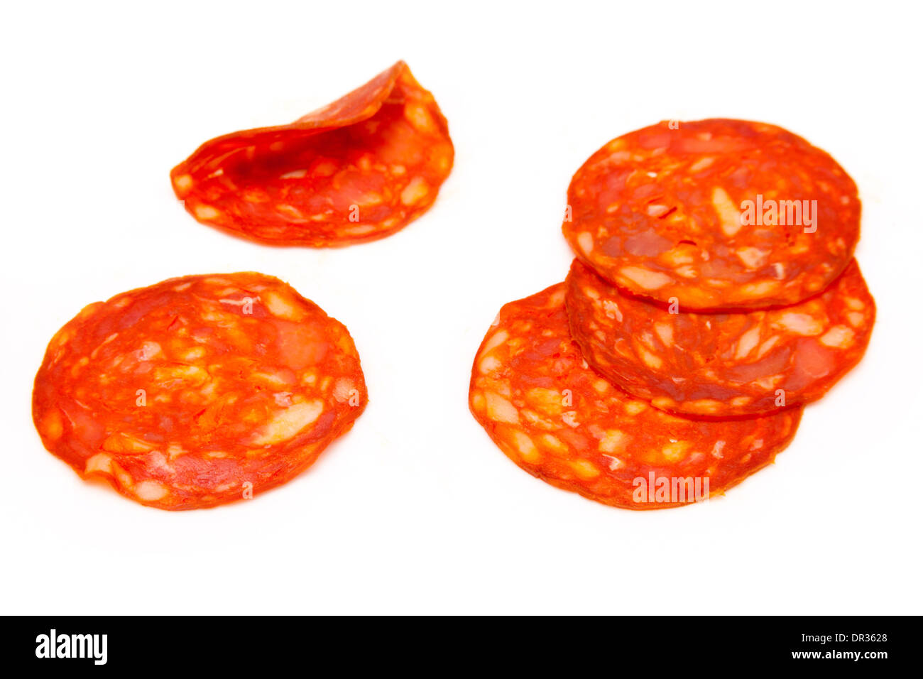Sliced Spanish chorizo sausage isolated on a white studio background ...